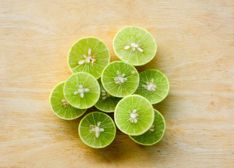 Stack of Cutting Fresh Lemon Lime Fruits on Wooden Chopping Board ...