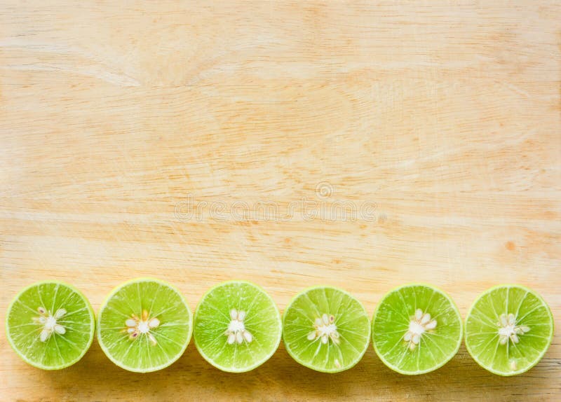Stack of Cutting Fresh Lemon Lime Fruits on Wooden Chopping Board ...