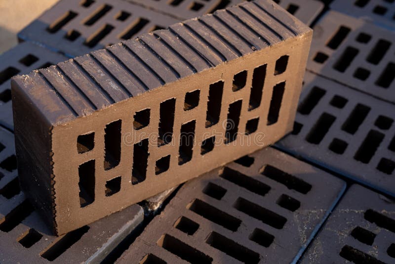 A Stack of Dark Brown Hollow Bricks at a Construction Site at Sunset ...