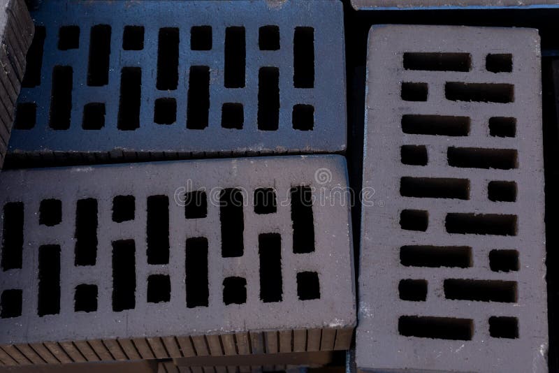 A Stack of Dark Brown Hollow Bricks at a Construction Site at Sunset ...