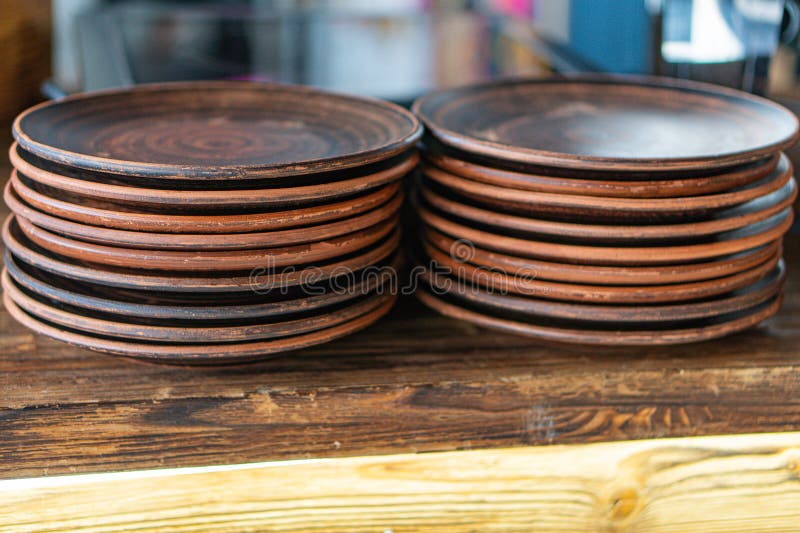 A Stack of Dark Brown Wooden Plates with Grain Patterns, Slightly Askew ...