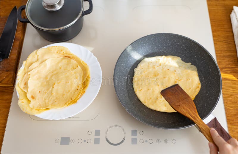 Stack of Delicious Thin Pancakes on Frying Pan, Top View Stock Photo ...