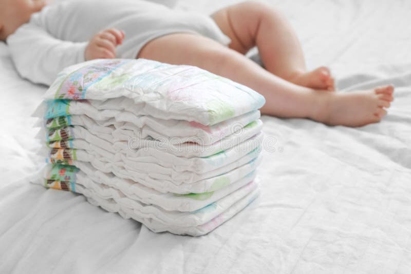 Stack of diapers on bed stock image. Image of cute, disposable - 227096583