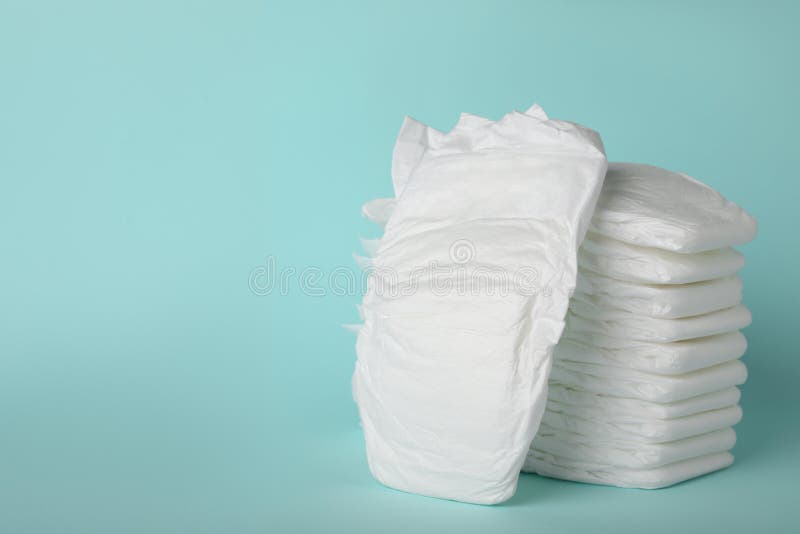Stack of Diapers on Blue Background. Space for Text Stock Photo - Image ...