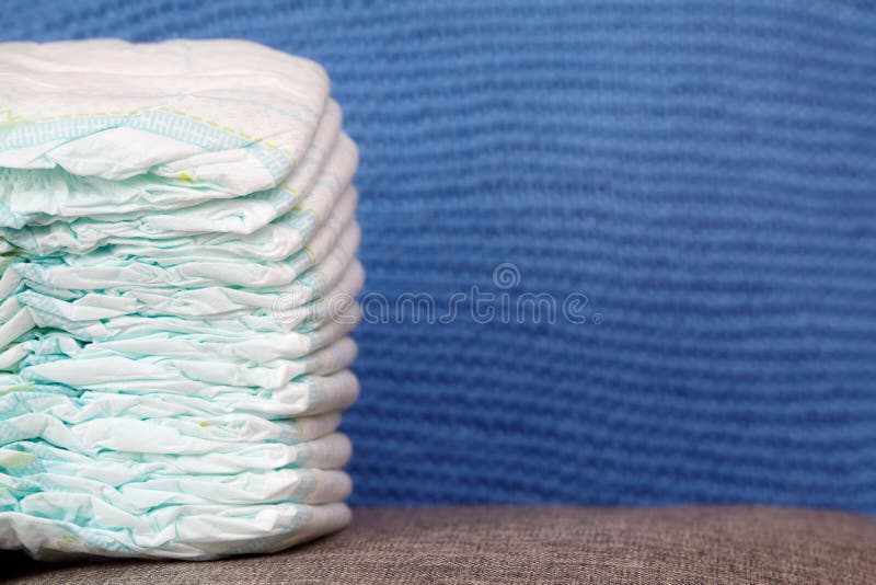 Stack of Diapers or Nappies on Blue Knitted Background Stock Image ...