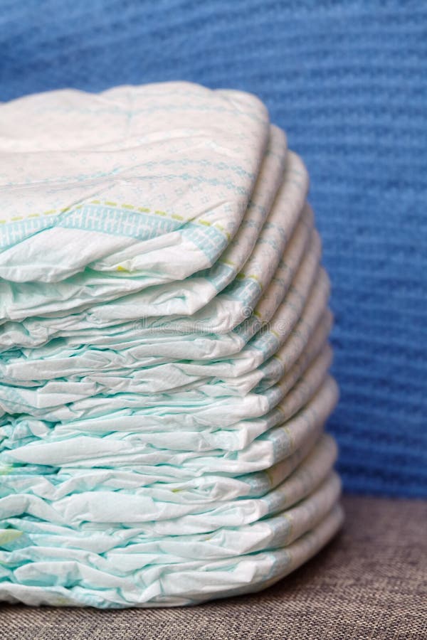 Stack of Diapers or Nappies on Blue Knitted Background Stock Photo ...
