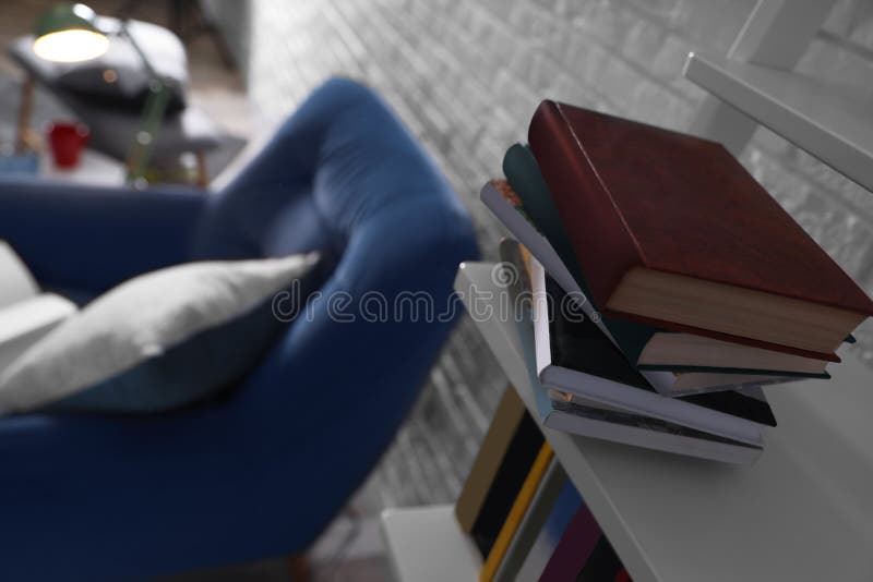 Stack of Different Books on Shelf in Room Stock Image - Image of design ...