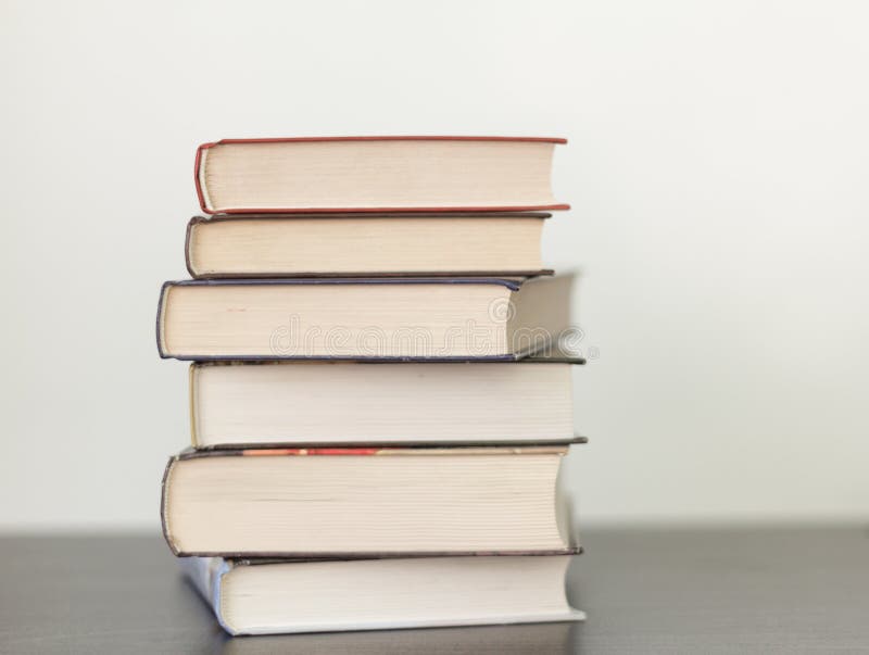 A Stack of Different Books in a Thick Cover on the Table Stock Photo ...