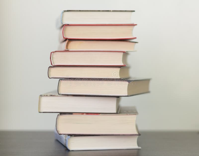 A Stack of Different Books in a Thick Cover on the Table Stock Image ...