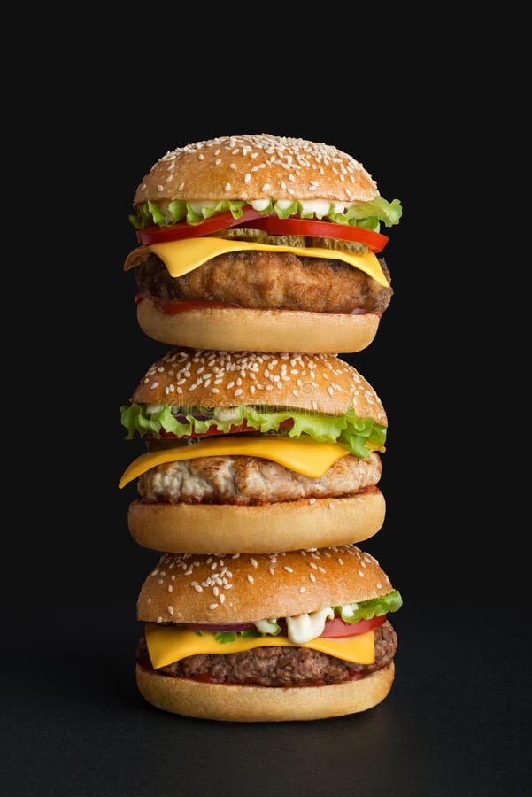 Stack of Different Burgers on Black Background Stock Image - Image of ...