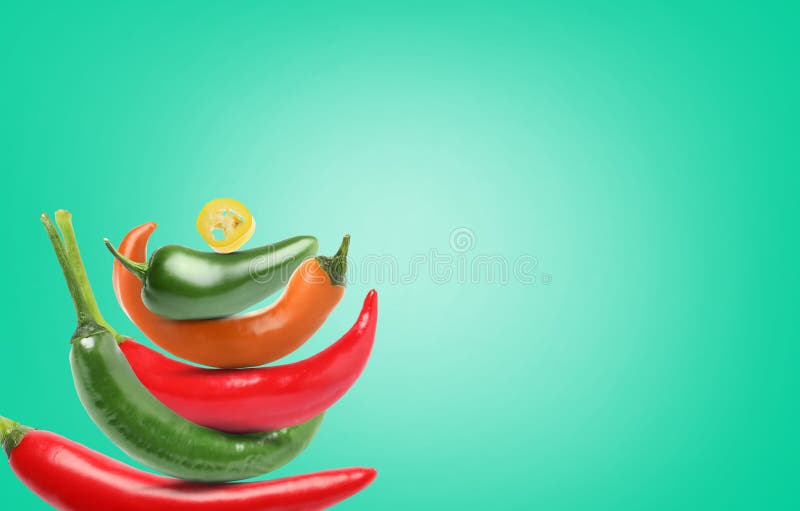 Stack of Different Chili Peppers on Turquoise Background, Space for ...