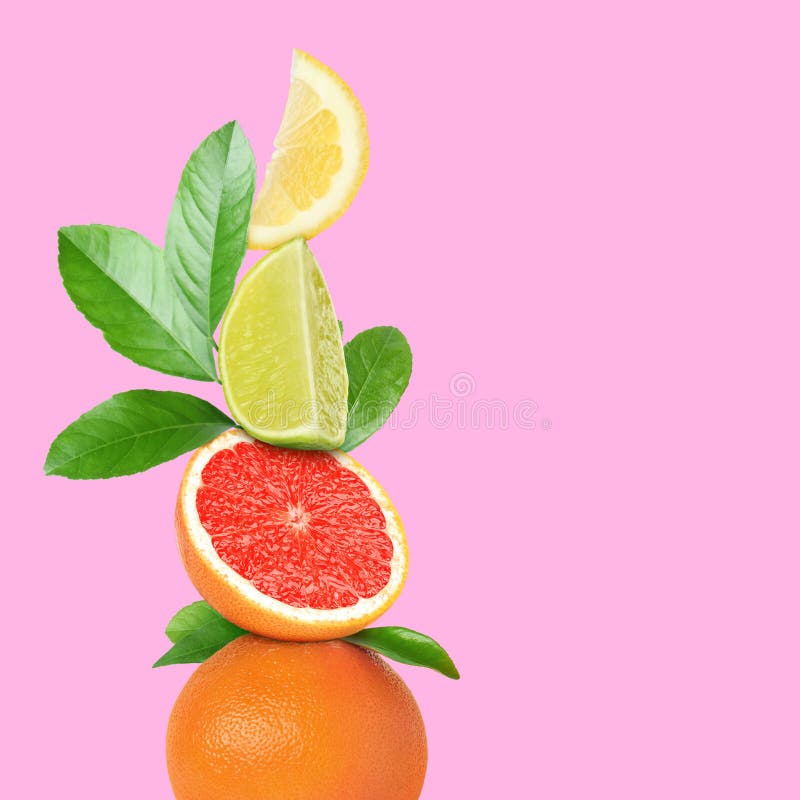 Stack of Different Fresh Citrus Fruits with Green Leaves on Pink ...
