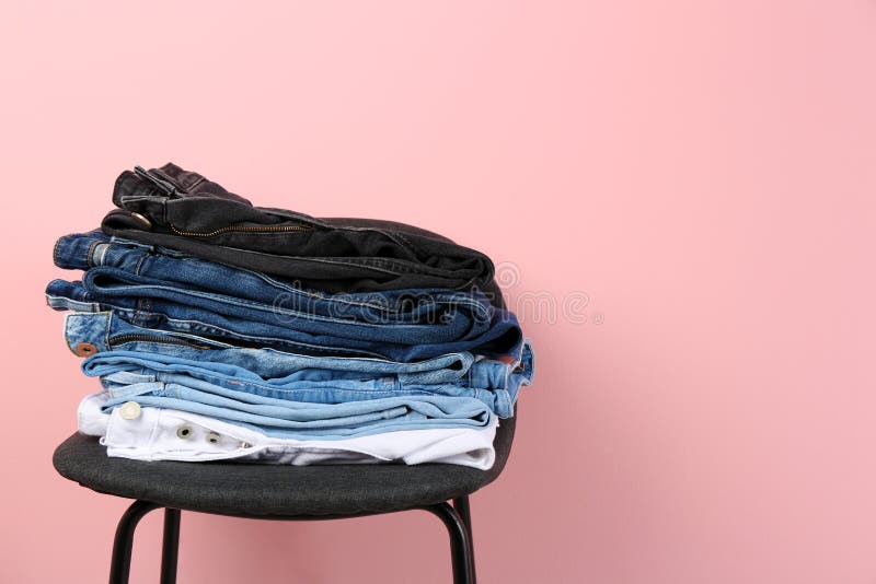 Stack of Different Jeans on Stool Stock Image - Image of material ...