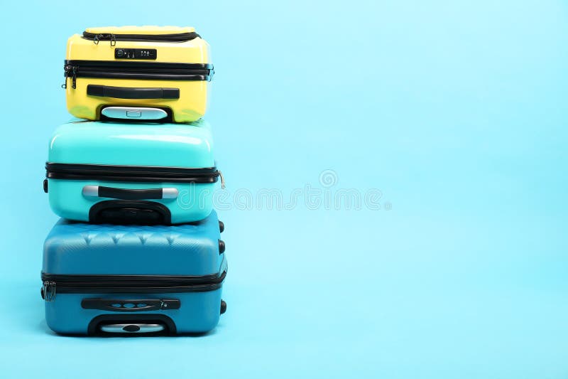 Stack of Different Suitcases on Light Blue Background, Space for Text ...