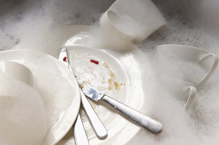Stack of Dirty Dishes and Silverware in Sink with Bubbles Stock Photo ...