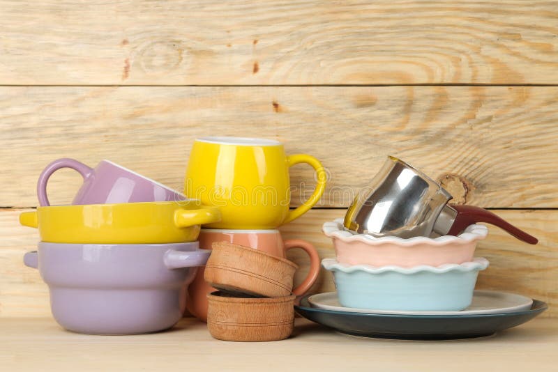 A Stack of Dishes. Colored Dishes on a Natural Wooden Table Stock Photo ...