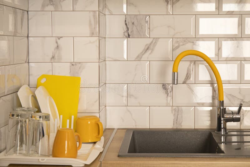 Stack of Dishes on the Dryer Near Grey Granite Sink with Yellow Basin ...