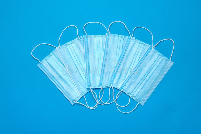 Stack of Disposable Blue Medical Face Masks on Blue Background Stock ...