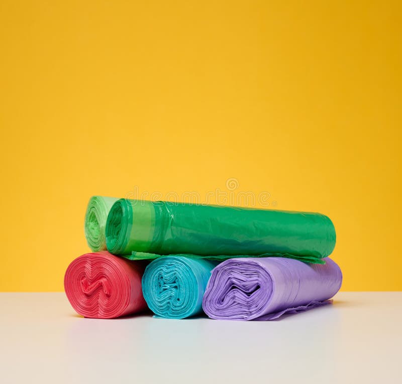 Stack of Disposable Plastic Trash Can Bags on a Yellow Background Stock ...