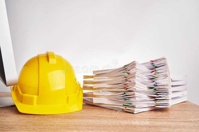 Stack Document with Yellow Engineer Hat on Wooden Computer Table Stock ...