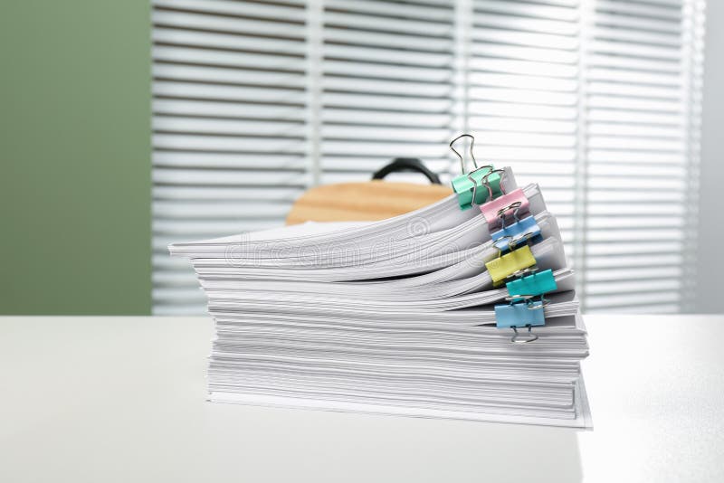 Stack of Documents Attached with Colorful Binder Clips on White Table ...