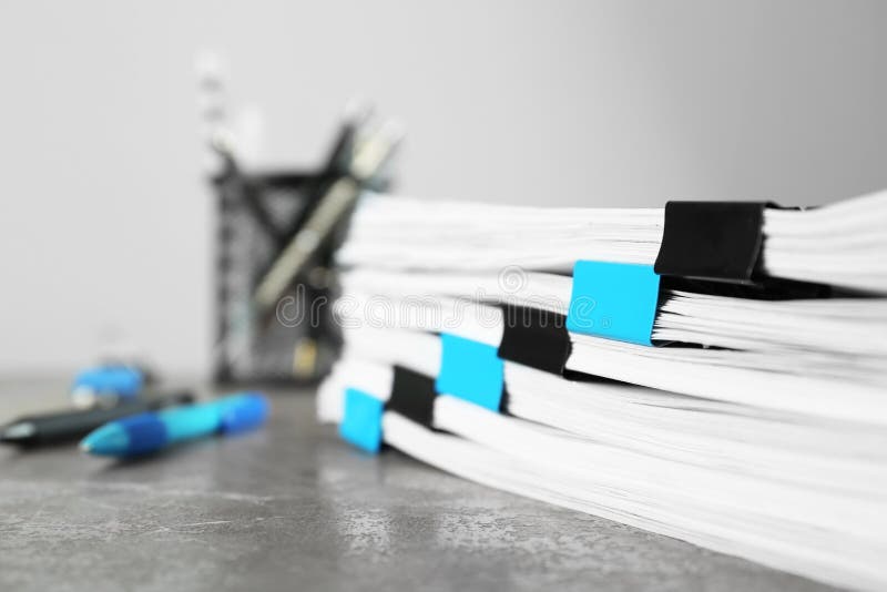 Stack of Documents with Binder Clips on Grey Stone Table, Closeup View ...