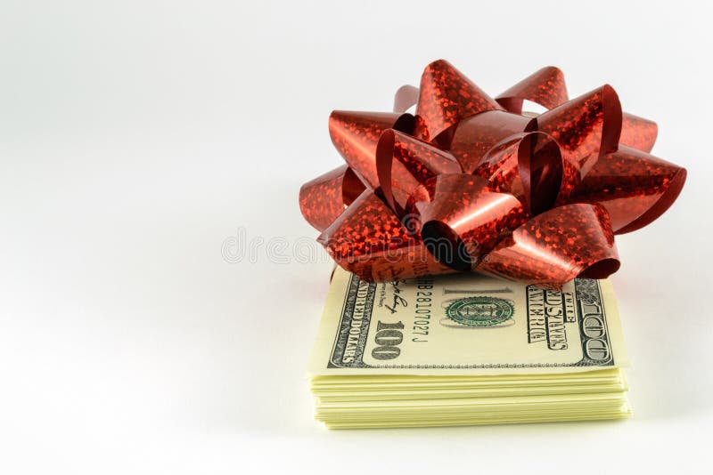 A Stack of Dollars and a Red Gift Bow Stock Photo - Image of dollar ...