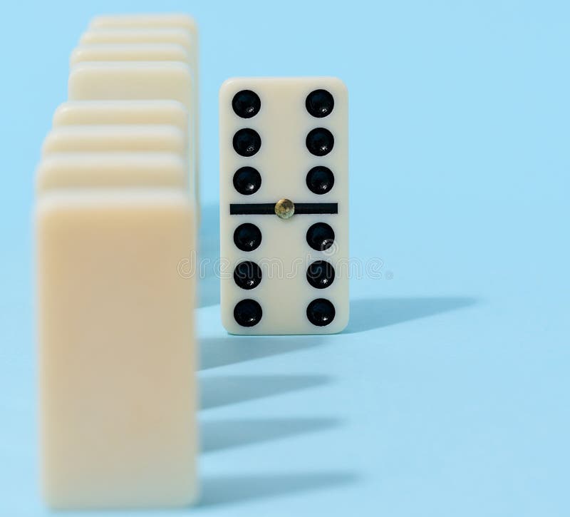 A Stack of Dominoes on a Blue Background, an Intellectual Game Stock ...