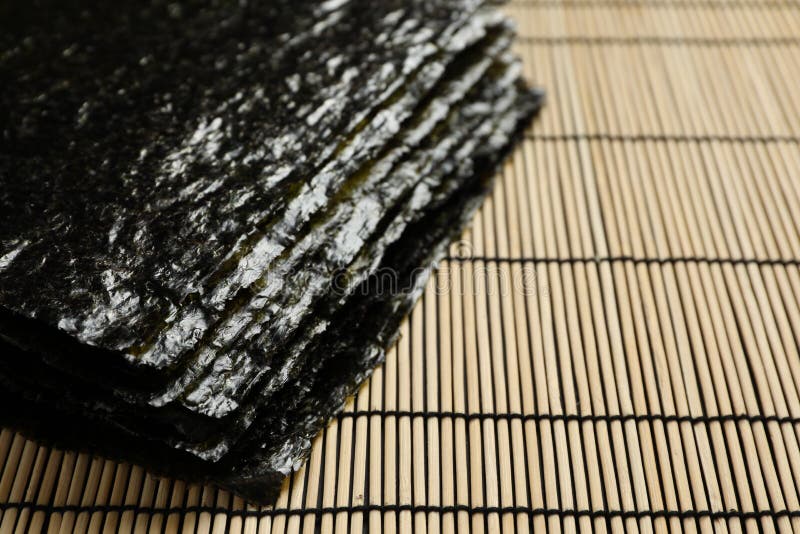 Stack of Dry Nori Sheets on Bamboo Mat, Closeup. Space for Text Stock ...