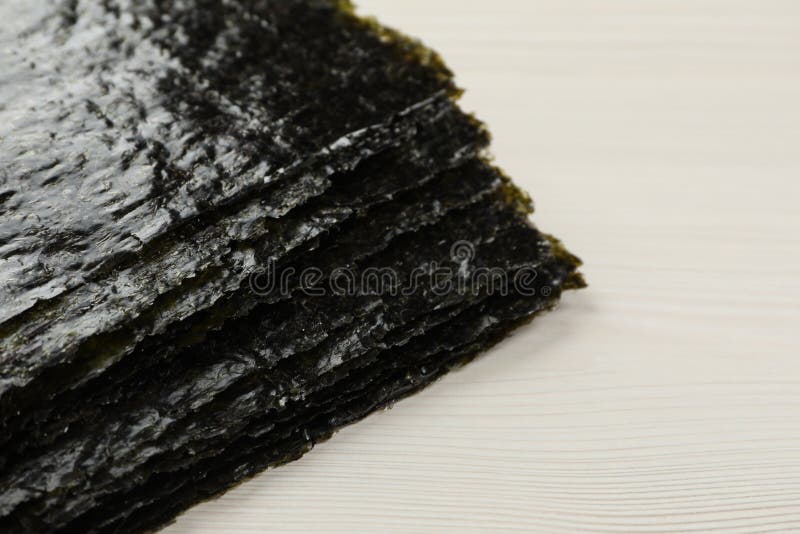 Stack of Dry Nori Sheets on White Wooden Table, Closeup. Space for Text ...