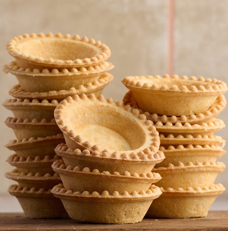 Stack of Empty Baked Round Canape Baskets on a Wooden Board, Round ...