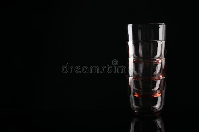 Stack of Empty Colorful Whiskey Glasses on Black Background Stock Photo ...