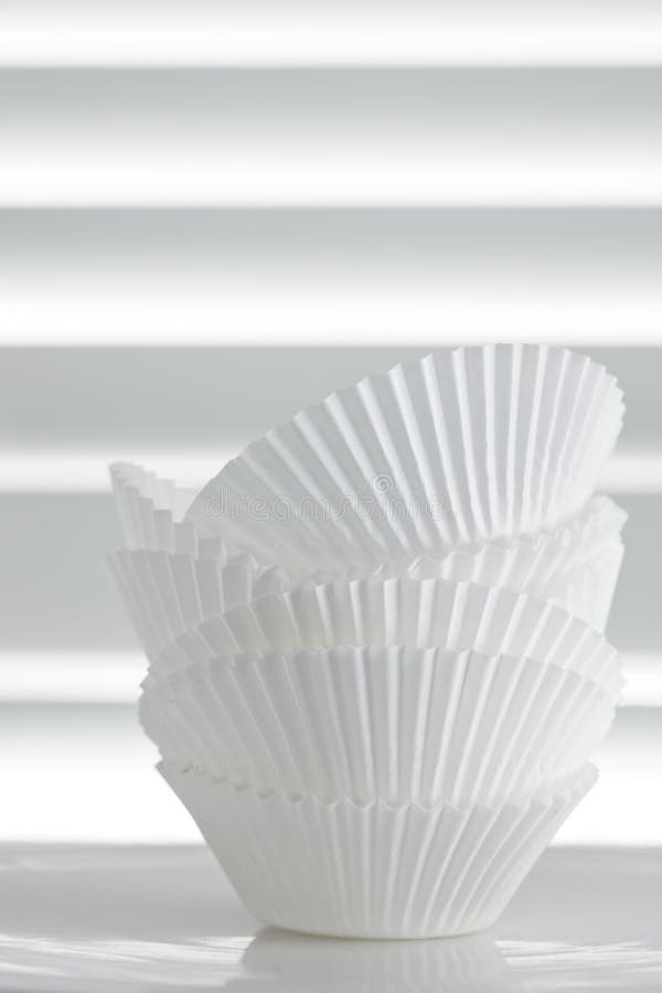 Stack of Empty Cupcake Cases Over White Slat Background Stock Photo ...