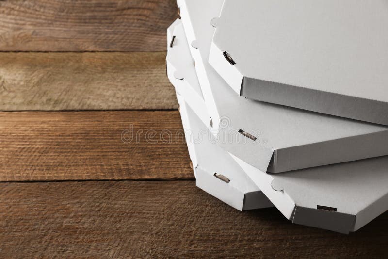 Stack of Empty Pizza Boxes on Wooden Table, Closeup. Space for Text ...