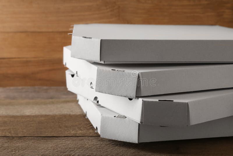 Stack of Empty Pizza Boxes on Wooden Table, Closeup. Space for Text ...