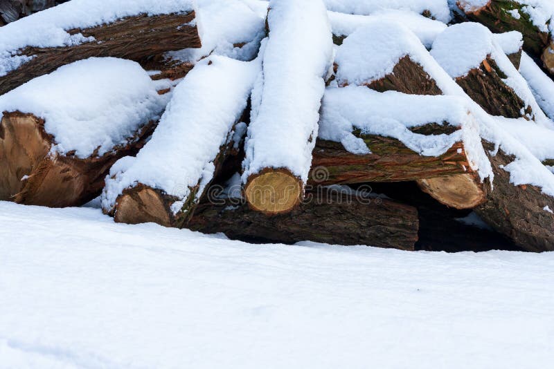 Stack of Firewood Covered with Snow Outdoors. Stack of Wood Cut. Snow ...
