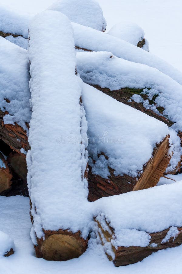 Stack of Firewood Covered with Snow Outdoors. Stack of Wood Cut. Snow ...