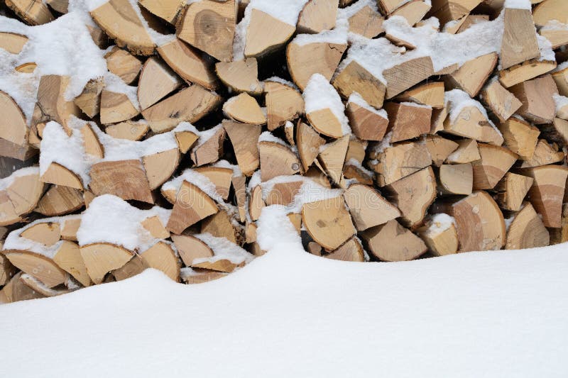 Stack of firewood and snow stock photo. Image of firewood - 303191430