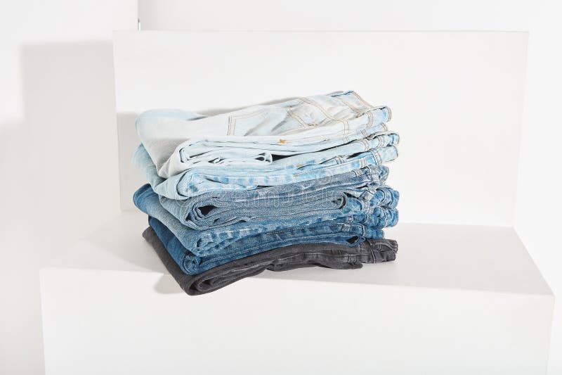 Stack of Folded Blue, Blue and Gray Jeans Close Up with Copy Space ...