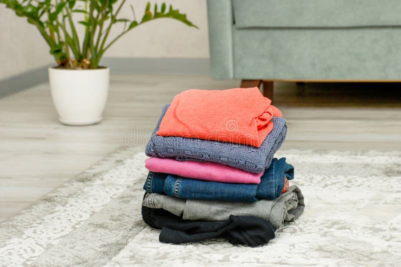 Stack of Folded Clothes on the Floor at Home Stock Image - Image of ...