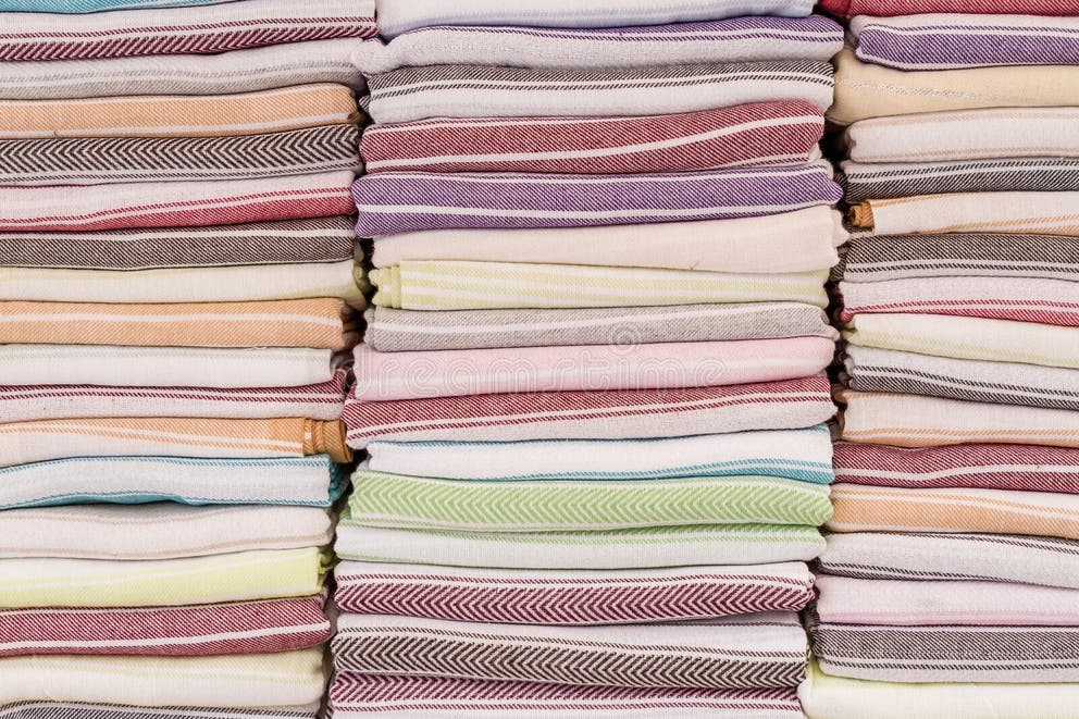 Stack of Folded Fabrics in Muted Tones Displaying Variety in Texture ...