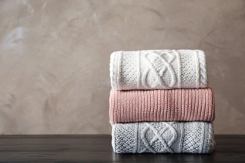 Stack of Folded Knitted Sweaters on Table Stock Photo - Image of season ...