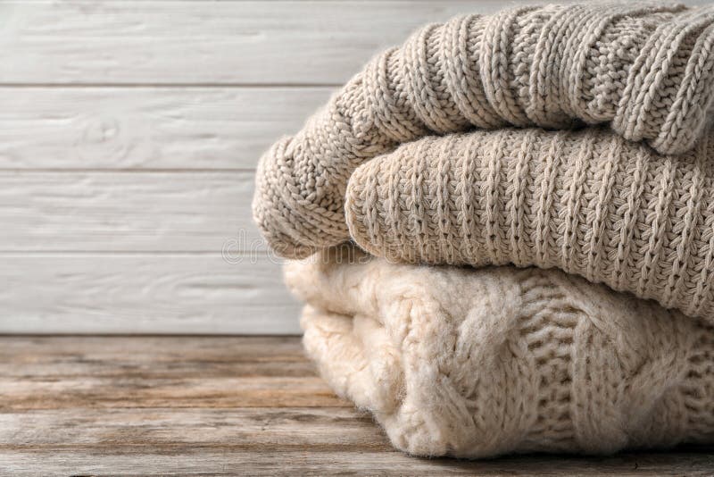 Stack of Folded Knitted Sweaters on Table Stock Image - Image of cold ...