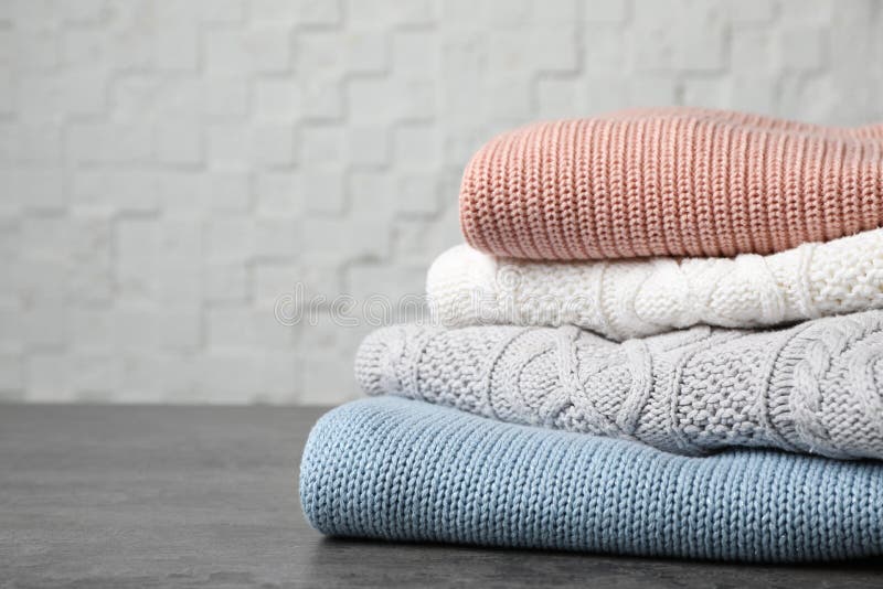 Stack of Folded Knitted Sweaters on Table Stock Image - Image of ...