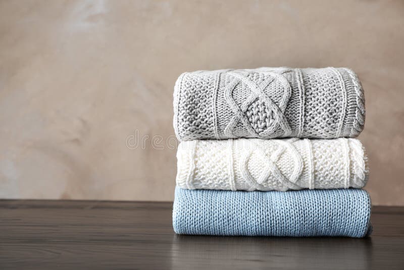 Stack of Folded Knitted Sweaters on Table Stock Image - Image of retail ...