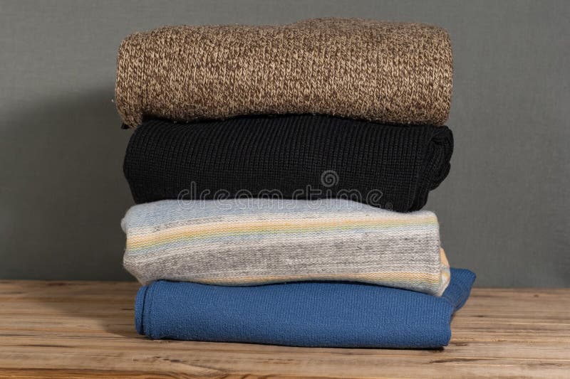 Stack of Folded Knitted Sweaters on Wooden Surface Stock Image - Image ...