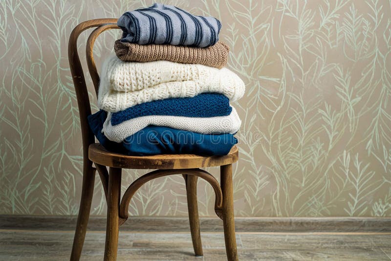 Stack of Folded Knitted Warm Clothes on a Chair. Change of Wardrobe for ...
