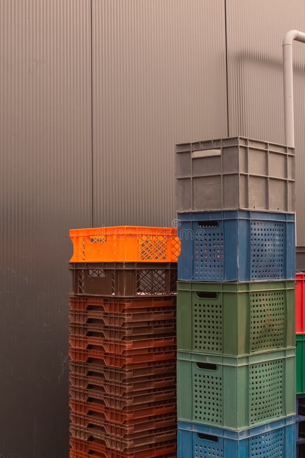 A Stack of Folded Multi-colored Plastic Boxes at the Back Entrance ...