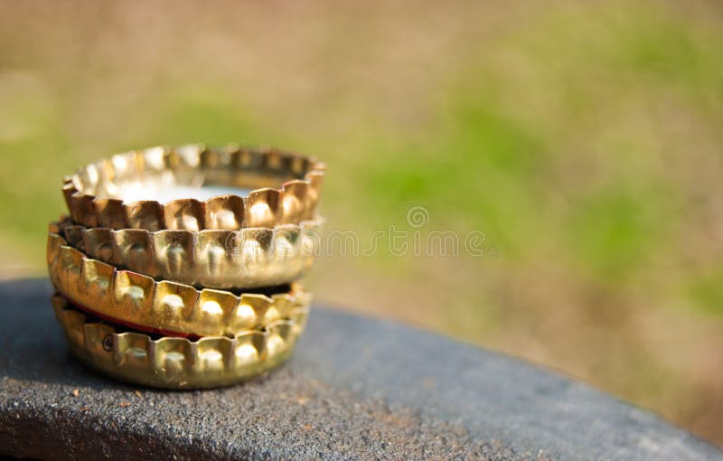 Stack of Four Metal Caps of Beer Bottles on a Bench Stock Image - Image ...