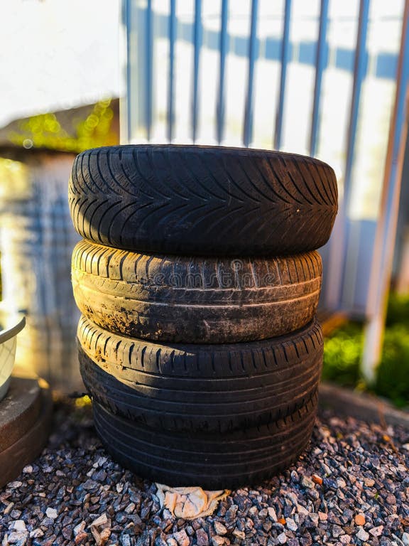 A Stack of Four Tires Sitting on Top of Each Other Stock Photo - Image ...